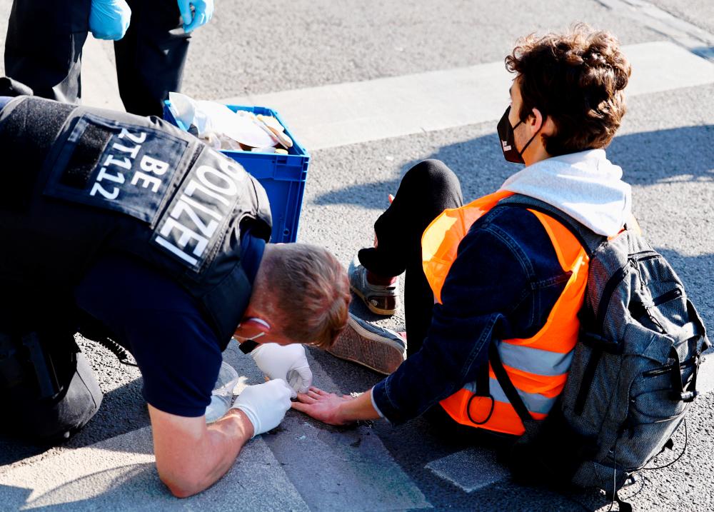 German climate activist jailed 8 months for glue protests